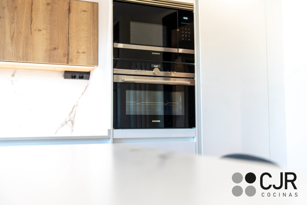 Cocinas en blanco y madera con peninsula Dekton Kairos CJR | Cocinas CJR Santos